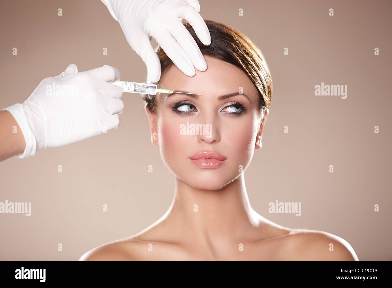 Beautiful woman gets botox injection in her face Stock Photo - Alamy