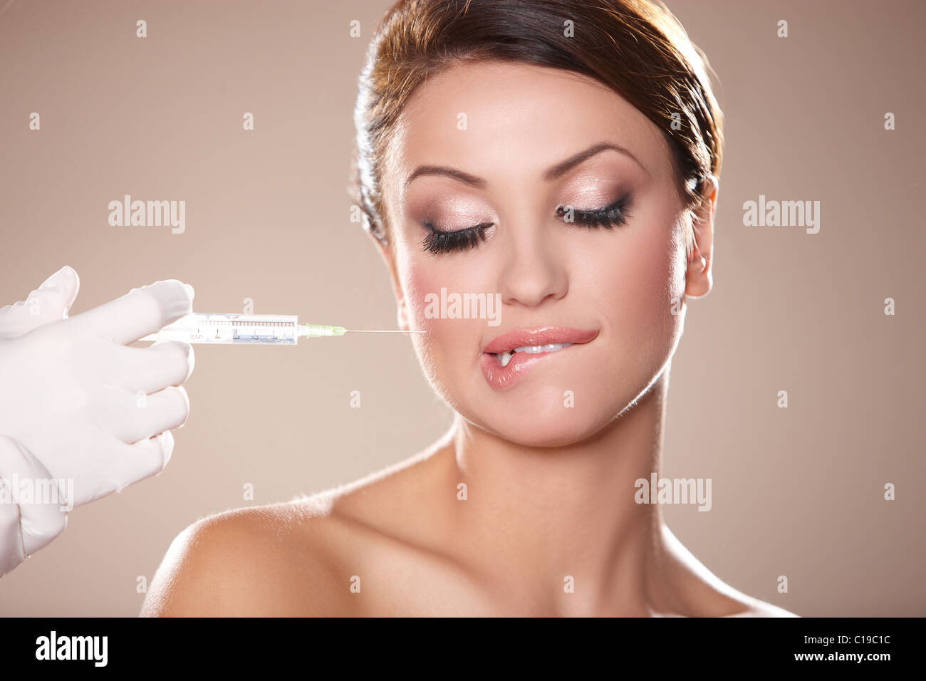Beautiful woman gets botox injection in her face Stock Photo - Alamy