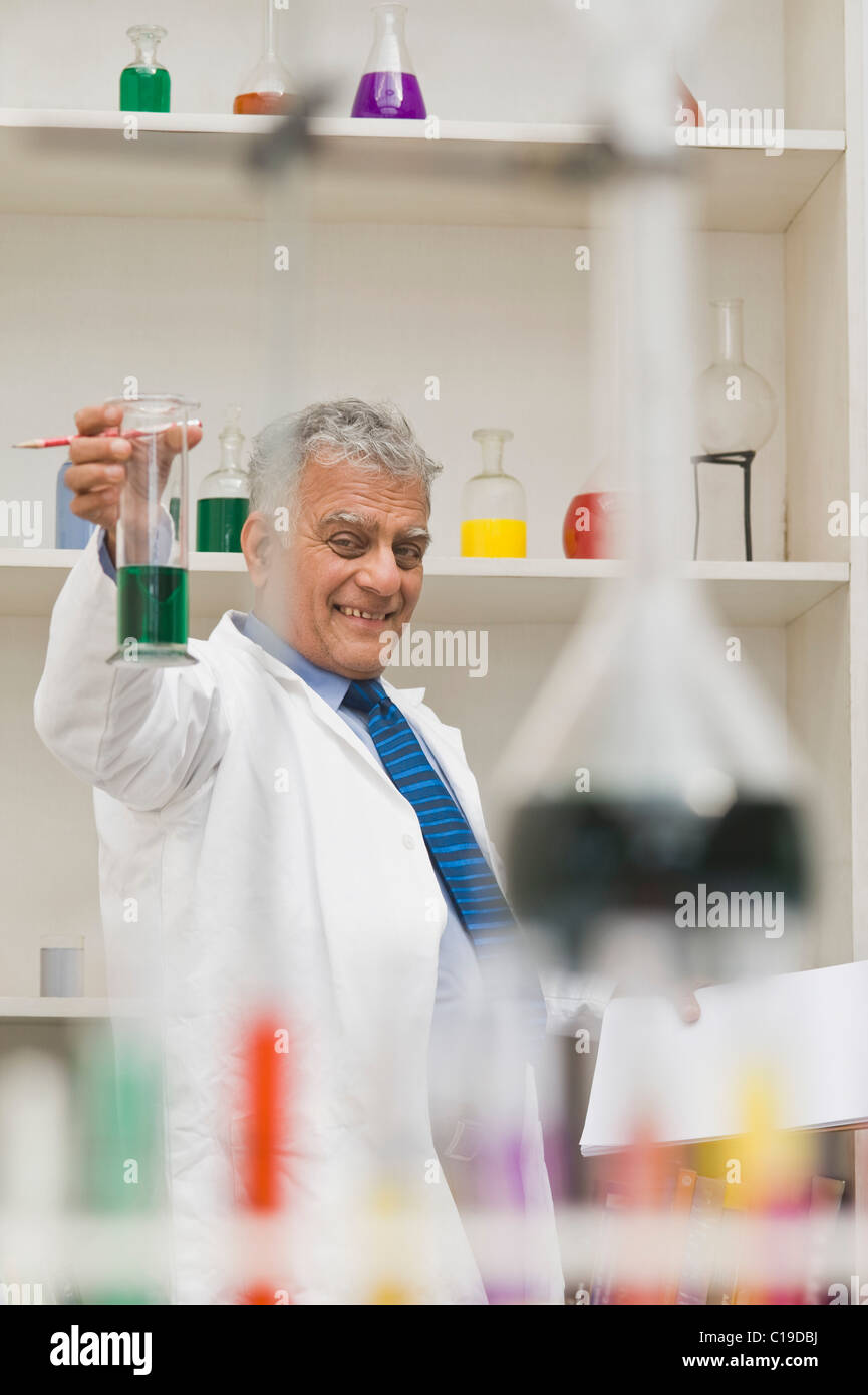 Scientist doing scientific experiment in a laboratory and smiling Stock ...