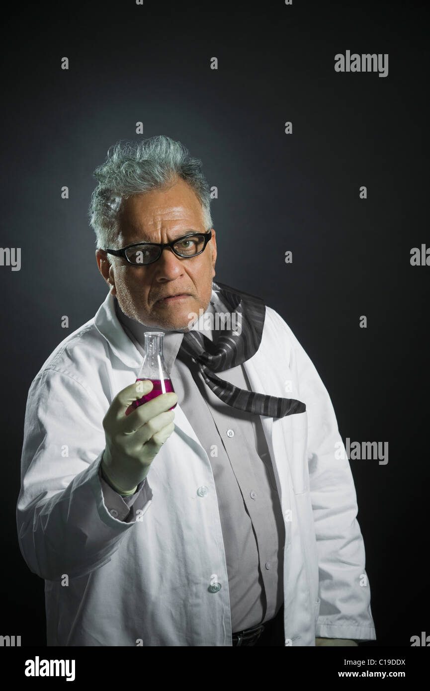Scientist showing a chemical flask Stock Photo - Alamy