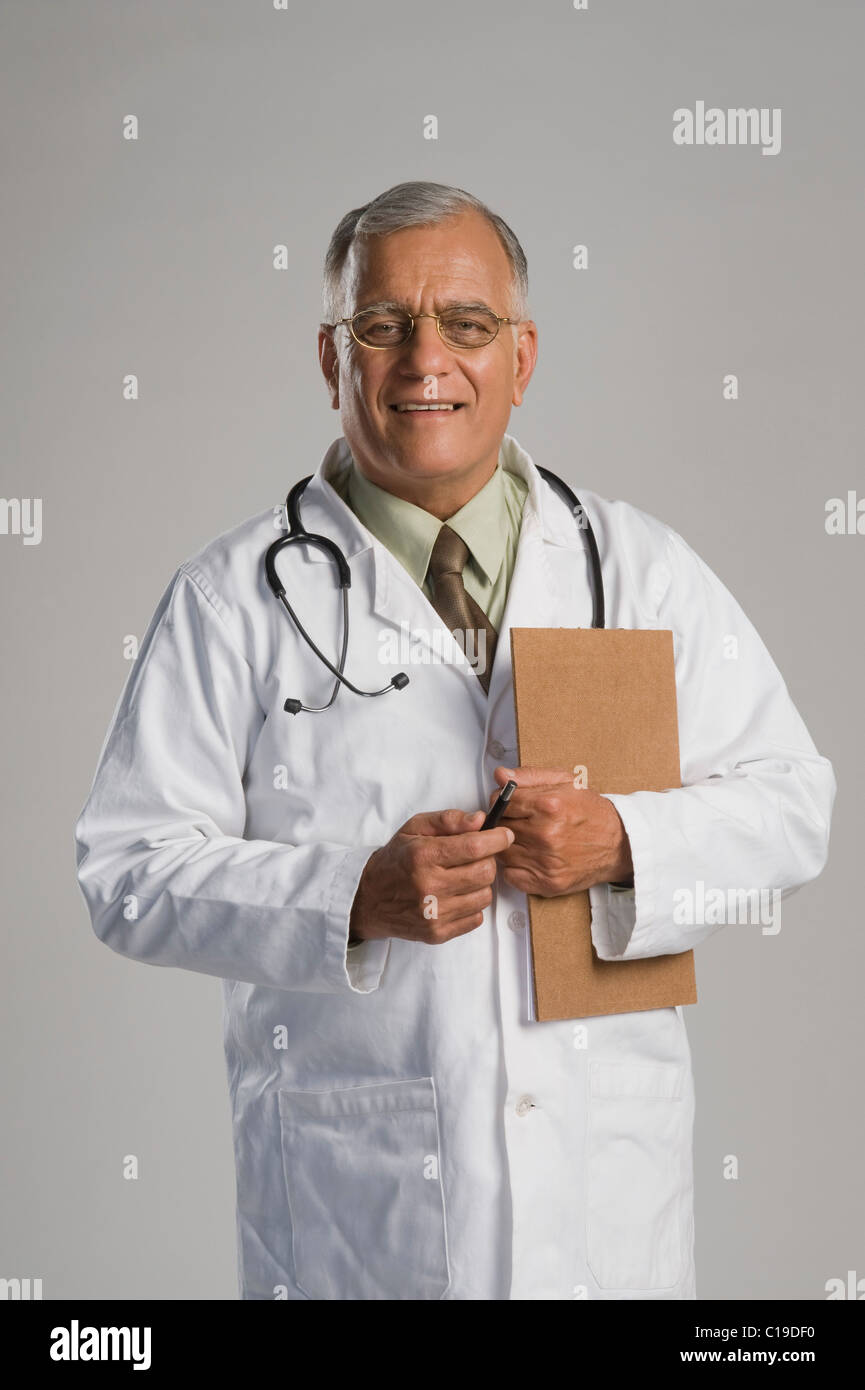 Doctor holding a clipboard and smiling Stock Photo - Alamy