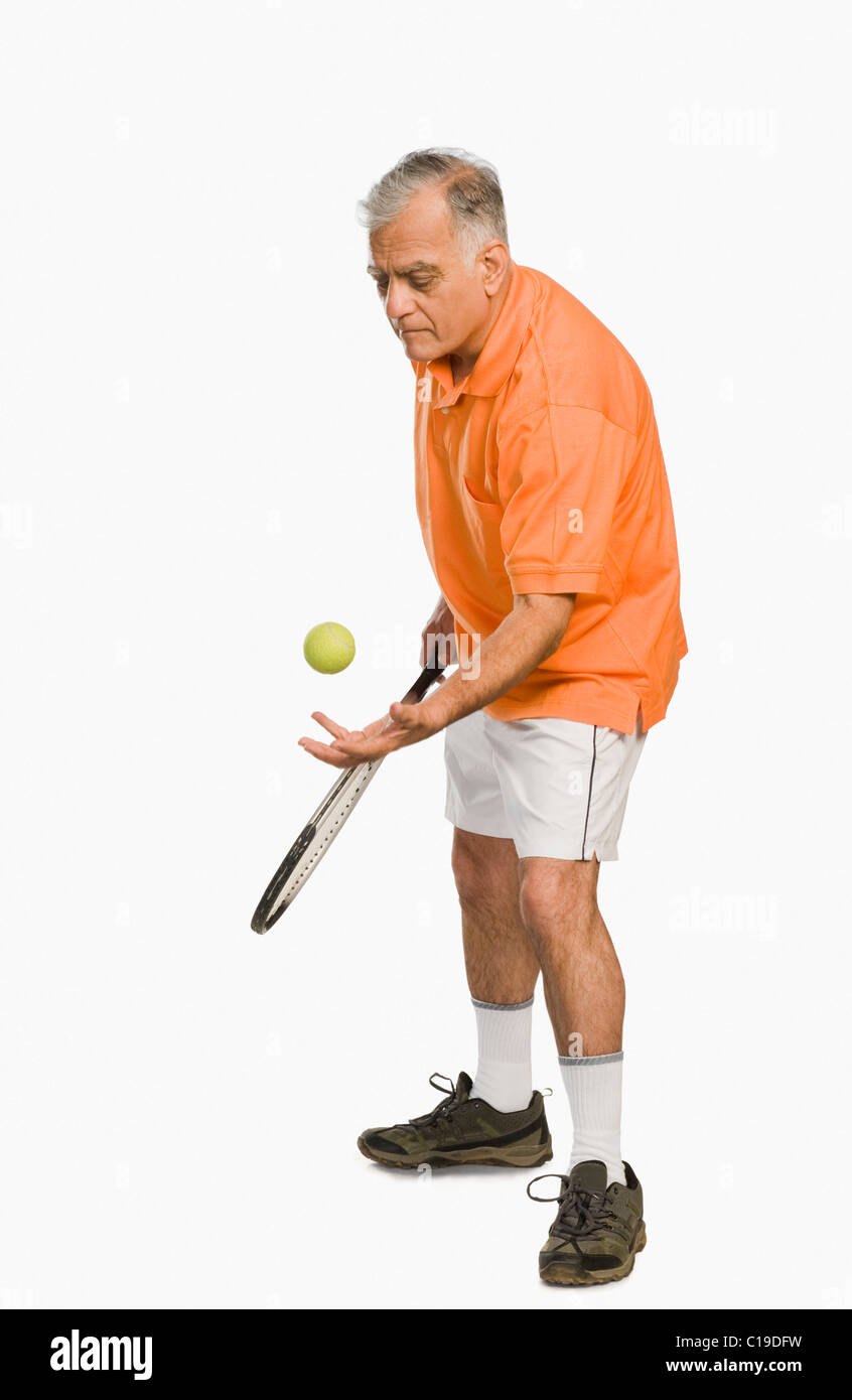 Man serving a tennis ball Stock Photo - Alamy