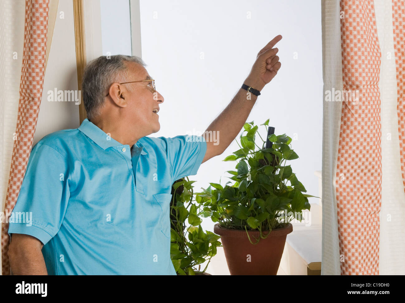 Man pointing through a window Stock Photo - Alamy