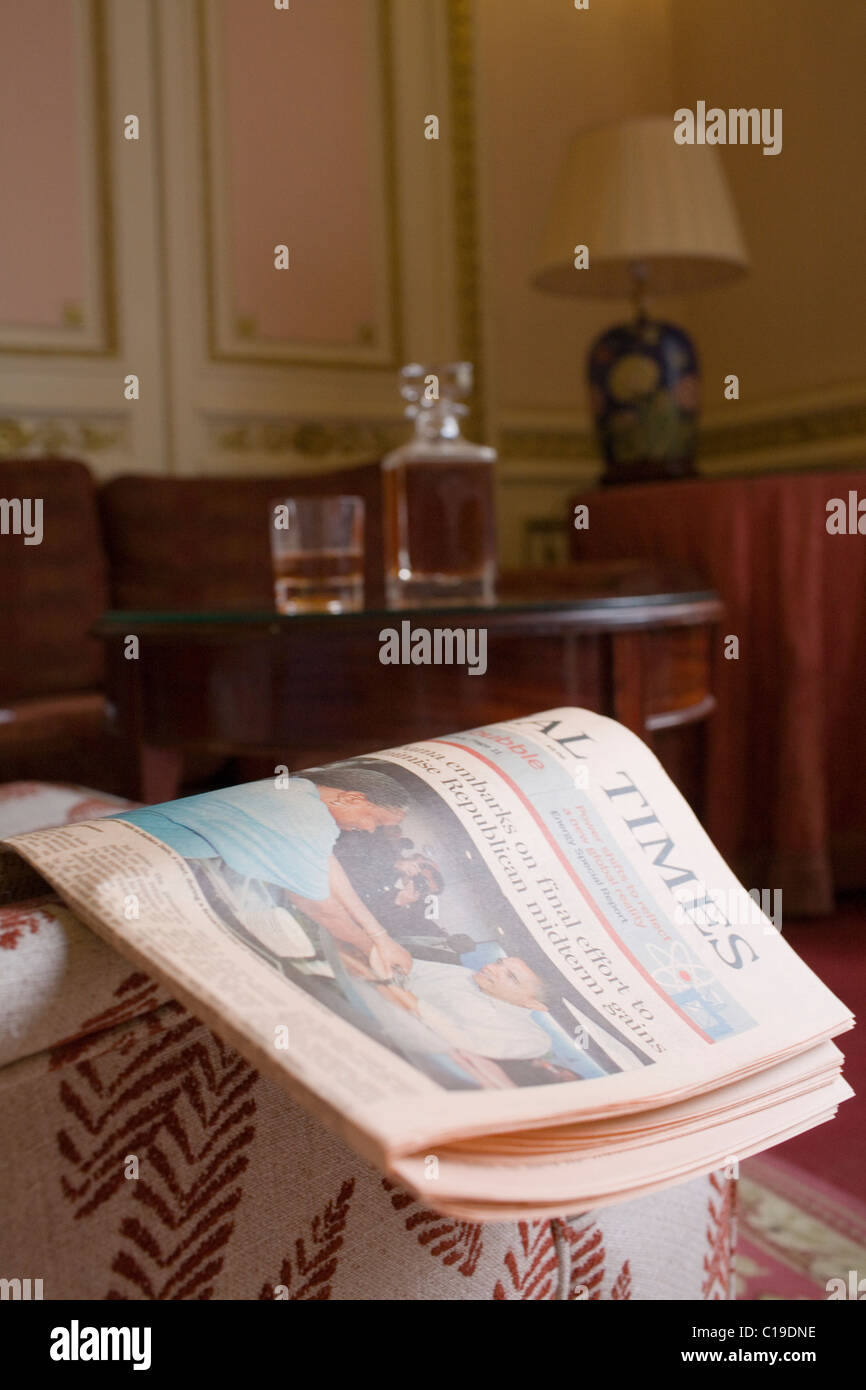 A copy of the pink Financial Times newspaper on the arm of a chair in ...
