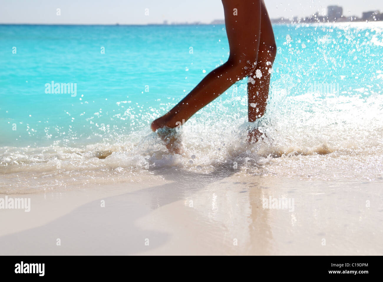 Woman Legs Walking Splashing Beach Water In Caribbean Turquoise Sea