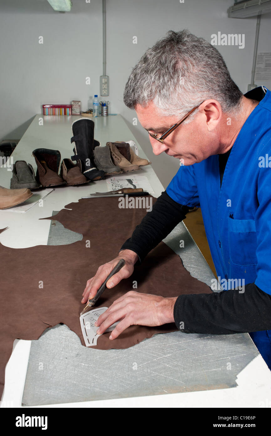 Skilled leather manufacture worker cutting some samples Stock Photo - Alamy