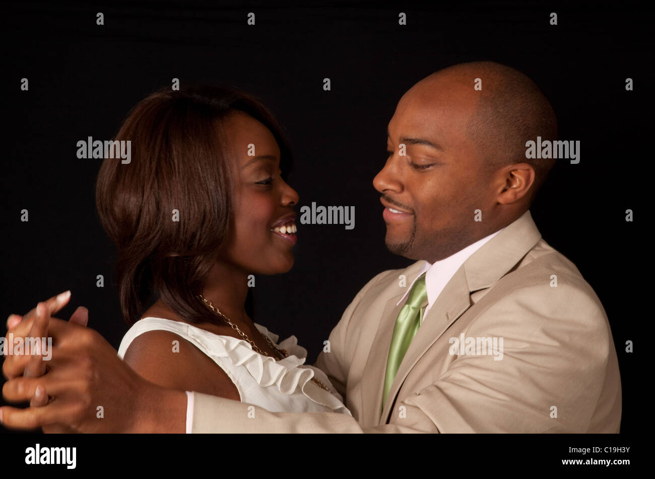 Dancing African American couple in business attire, with big smiles and ...