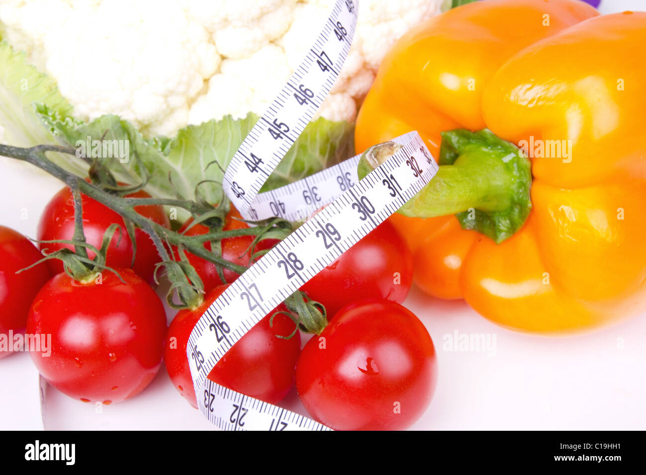 Fresh vegetables rounded by measuring tape, closeup Stock Photo - Alamy