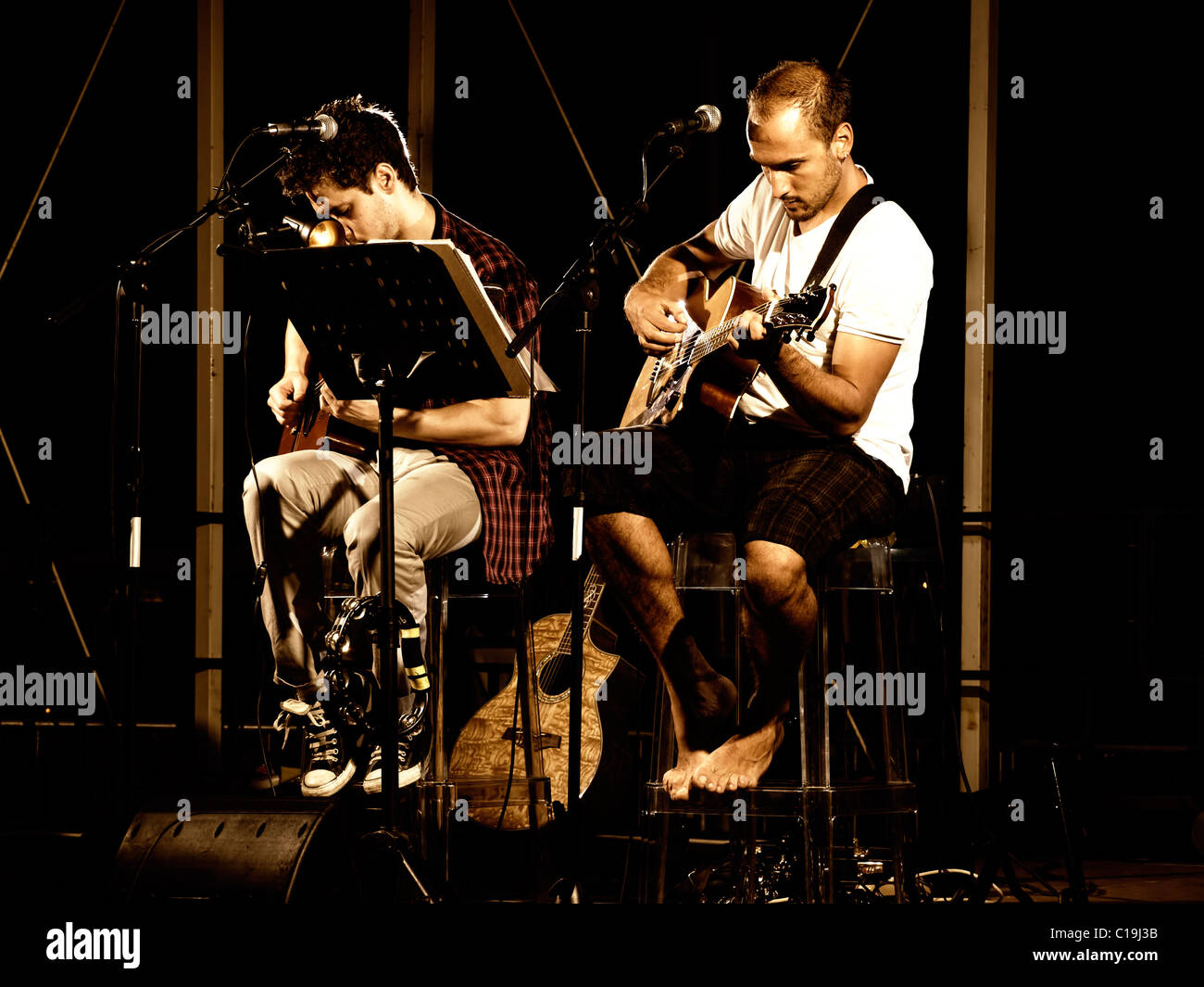 Two musicians on stage during the concert Stock Photo - Alamy