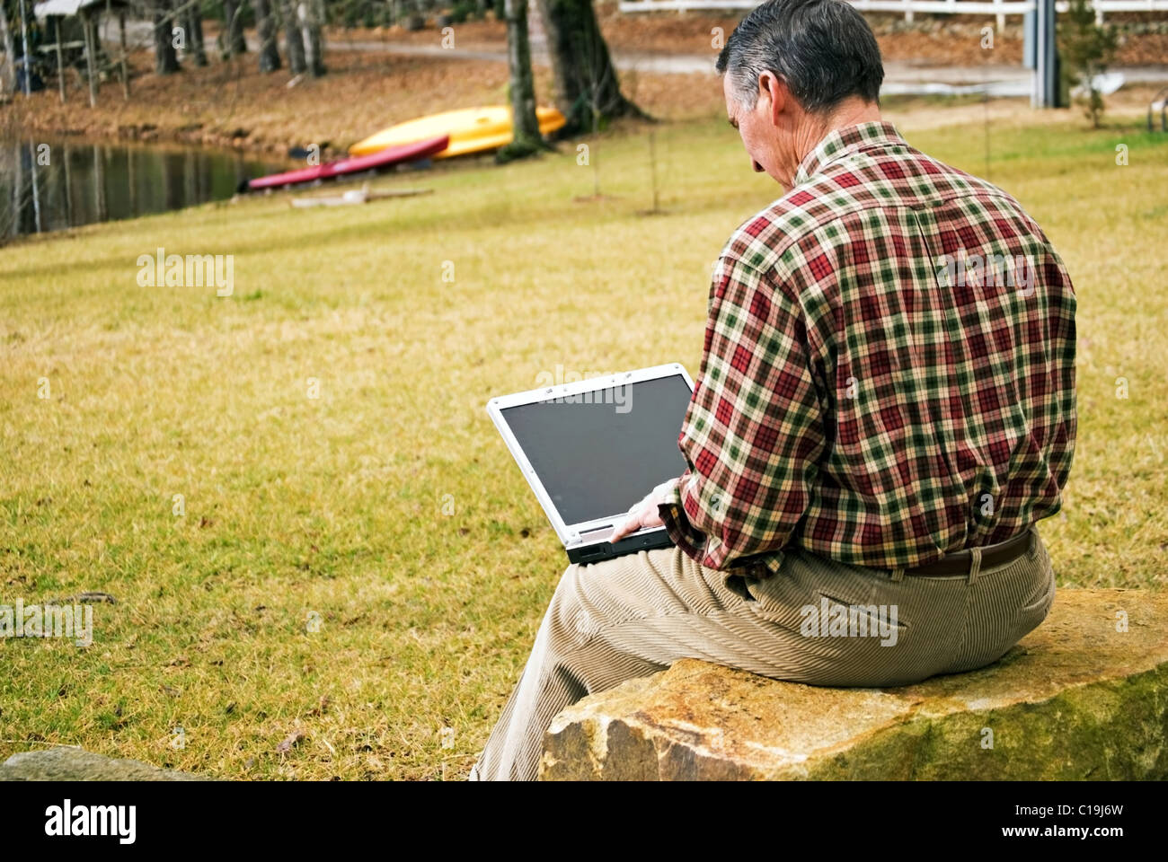 Man outdoors lake working laptop hi-res stock photography and images ...