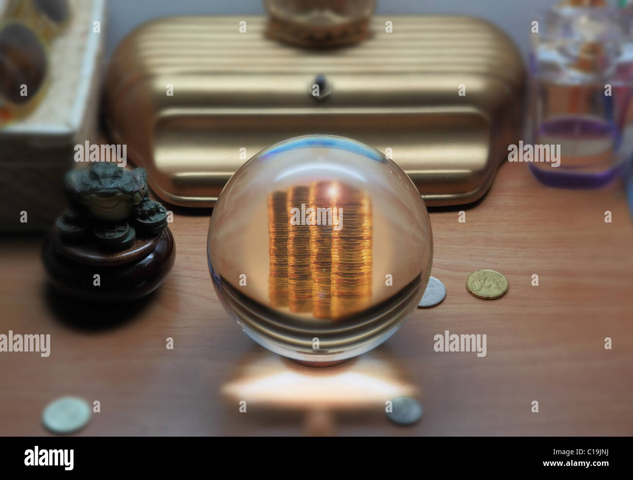 stack of coins seen in crystal ball, coins and various objects are also ...