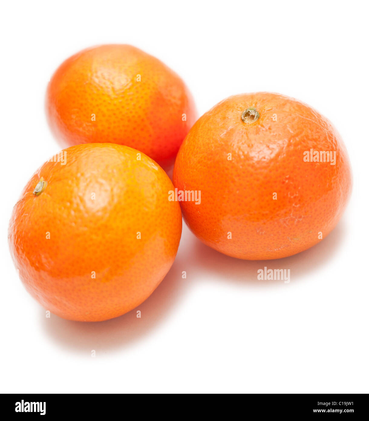 Group of three mandarin on white background Stock Photo - Alamy