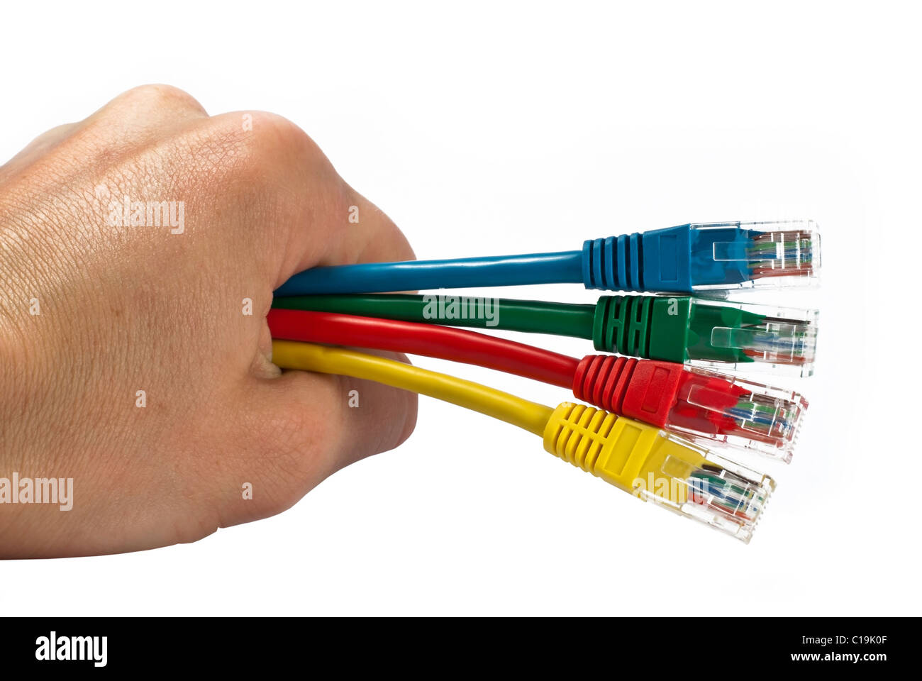 Hand holding four multi colored network cables isolated on white ...