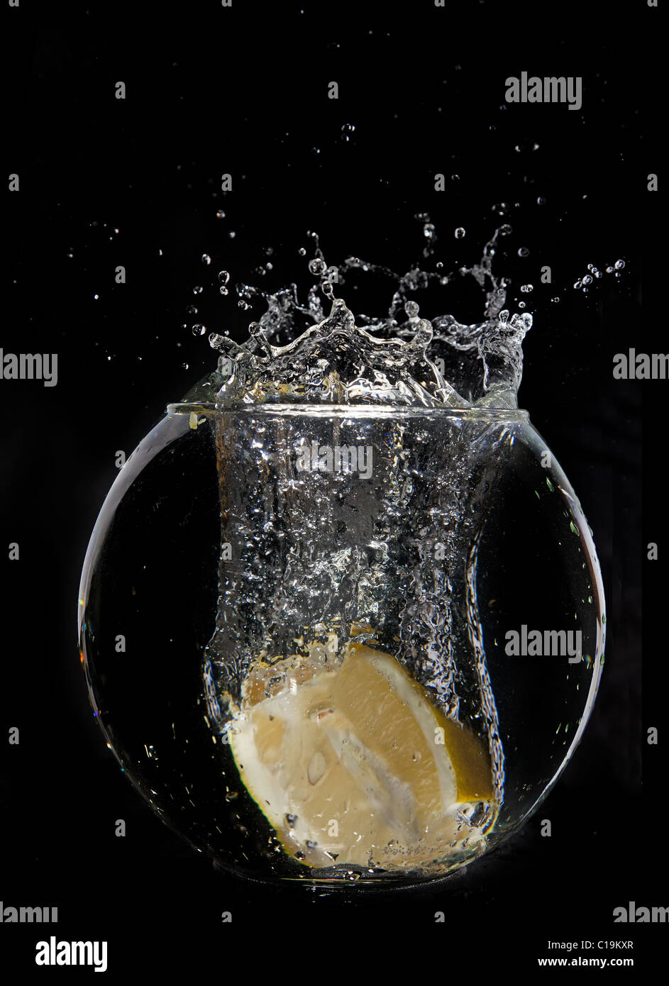 Yellow lemon half in water splash on dark background Stock Photo - Alamy