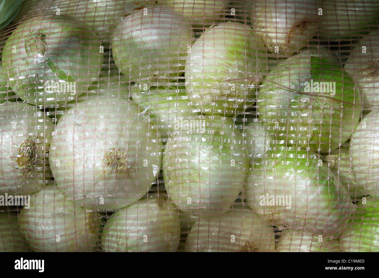 many onion view from sack net in market Stock Photo - Alamy