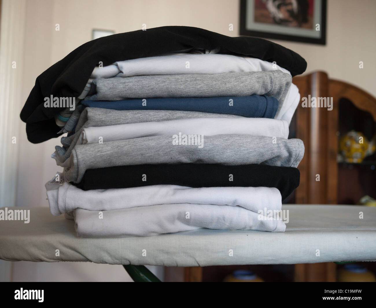 a stack of t shirts ironed and ready to be put away Stock Photo - Alamy