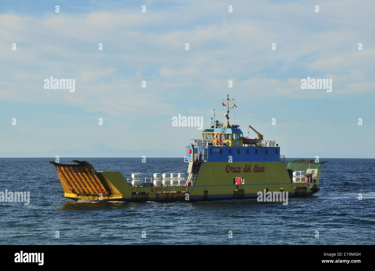 Yellow Cruz del Sur vehicle ferry on blue waters of Chacao Channel ...