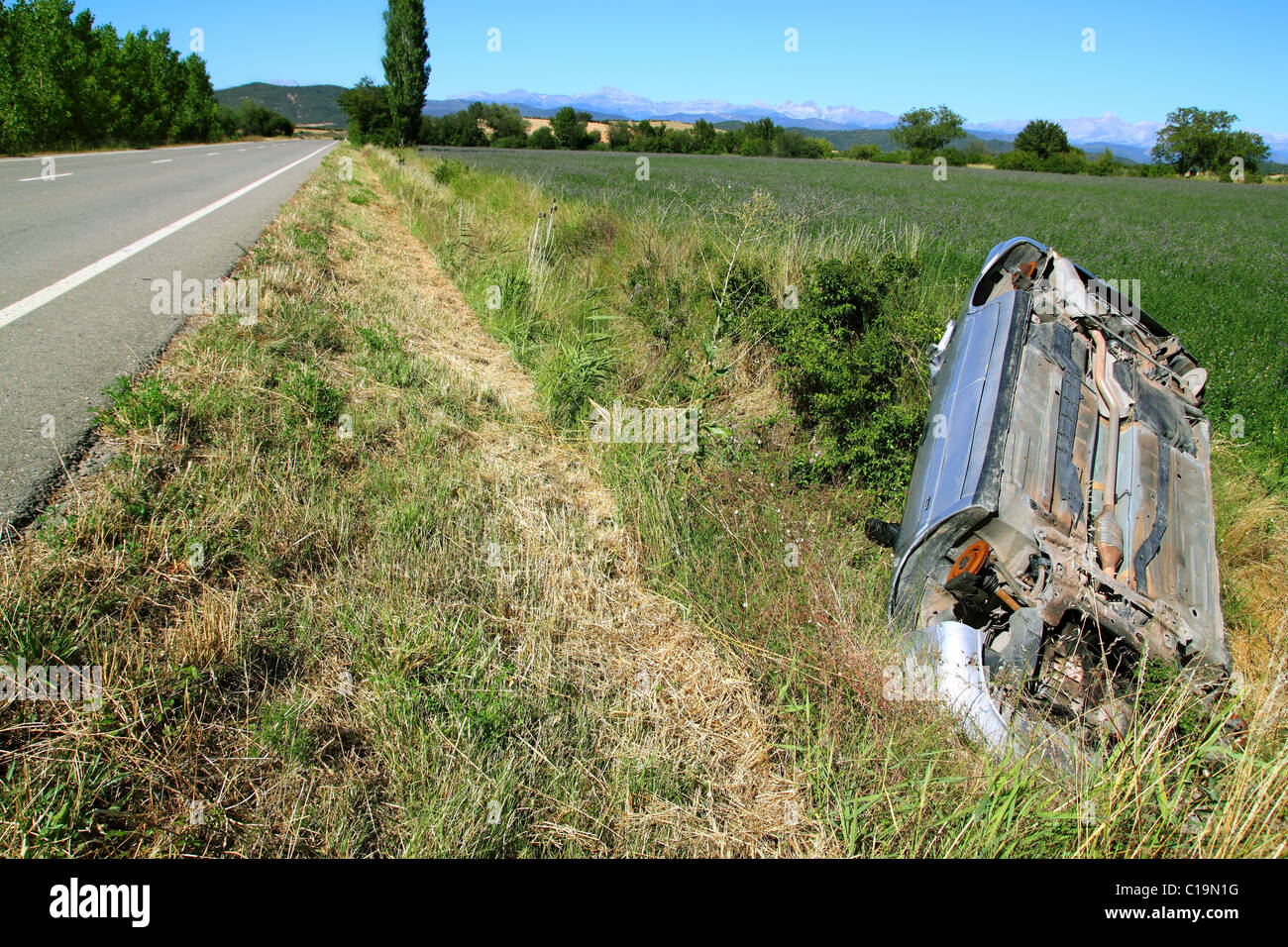 Car crash accident upside down vehicle off the road green landscape ...