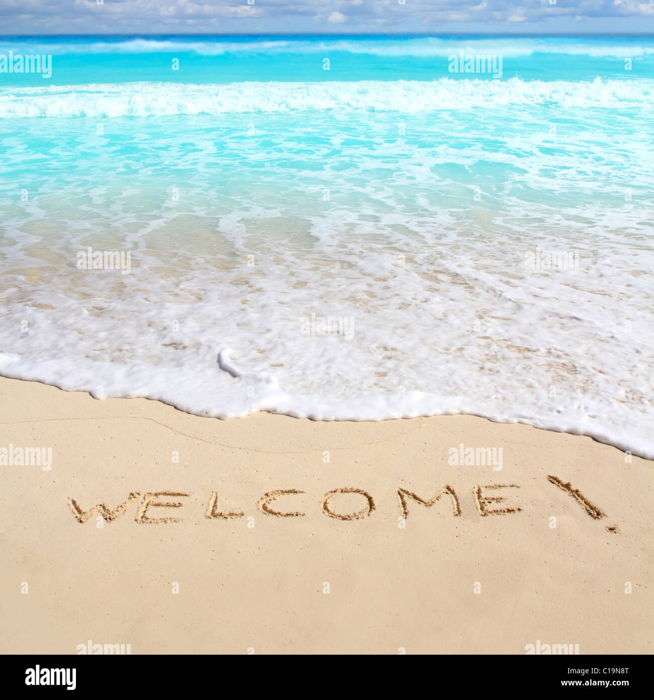 greetings welcome beach spell written on sand Caribbean tropical sea ...