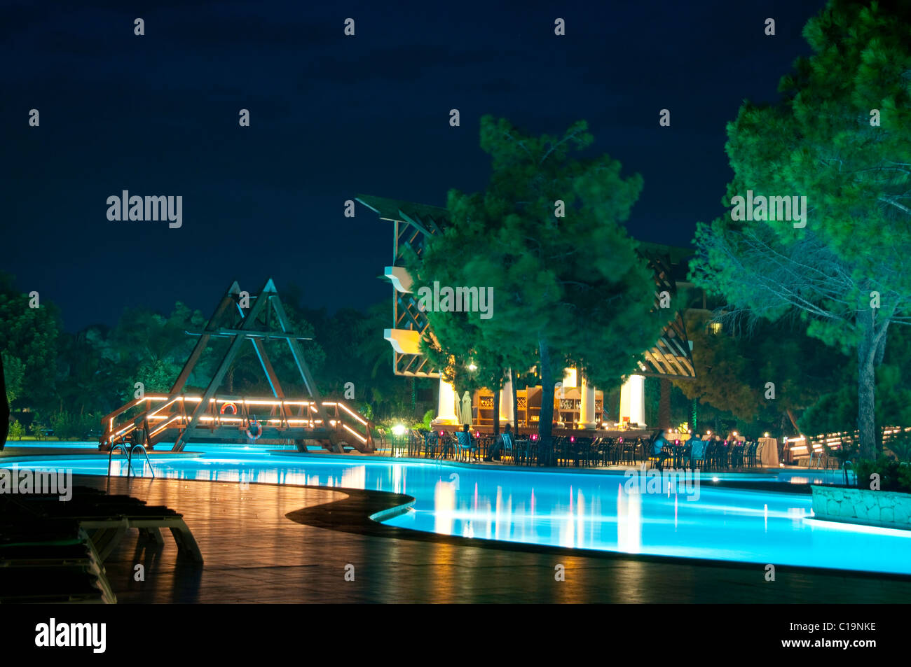 Swimming pool around bar in the resort hotel, at night time Stock Photo ...