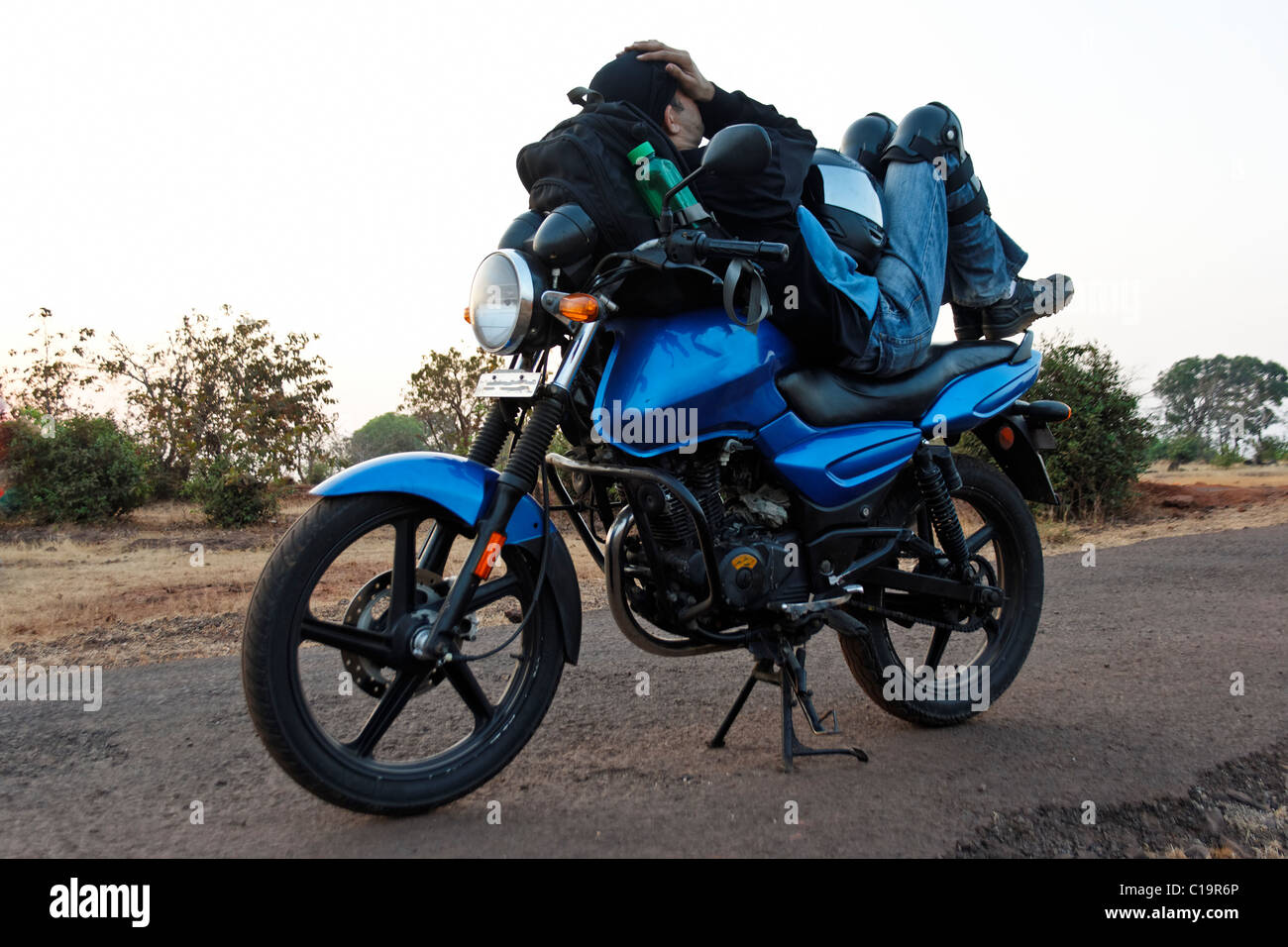 touring biker having a rest in indian wilderness on back of bike Stock ...