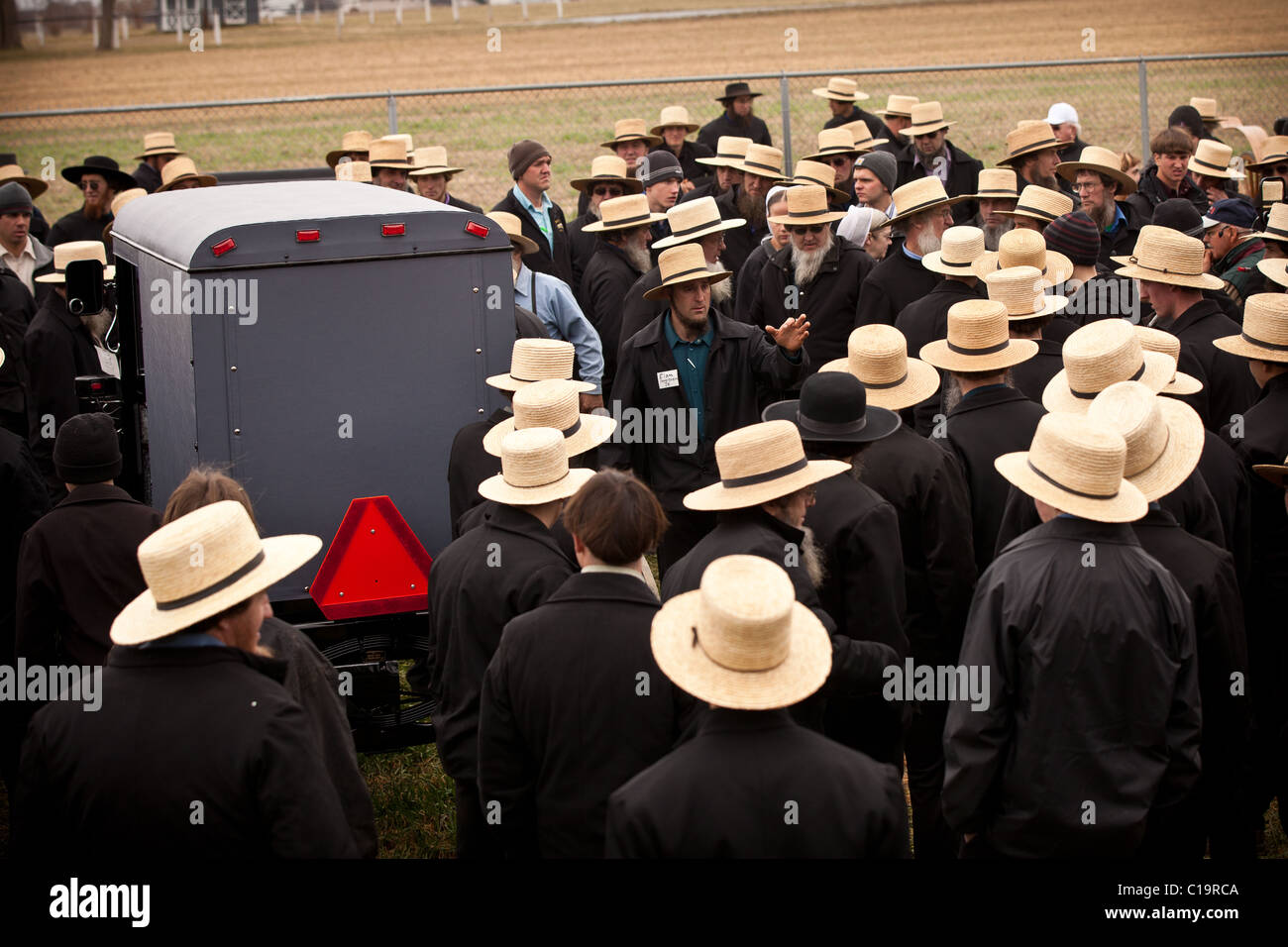 Amish men bid on a horse buggy during the Annual Mud Sale to support ...