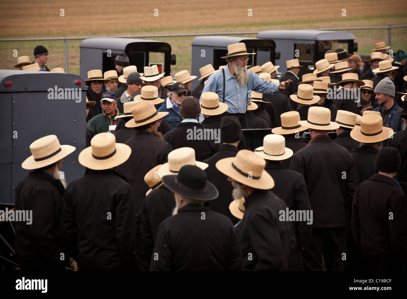 Amish men bid on horse buggies during the Annual Mud Sale to support ...