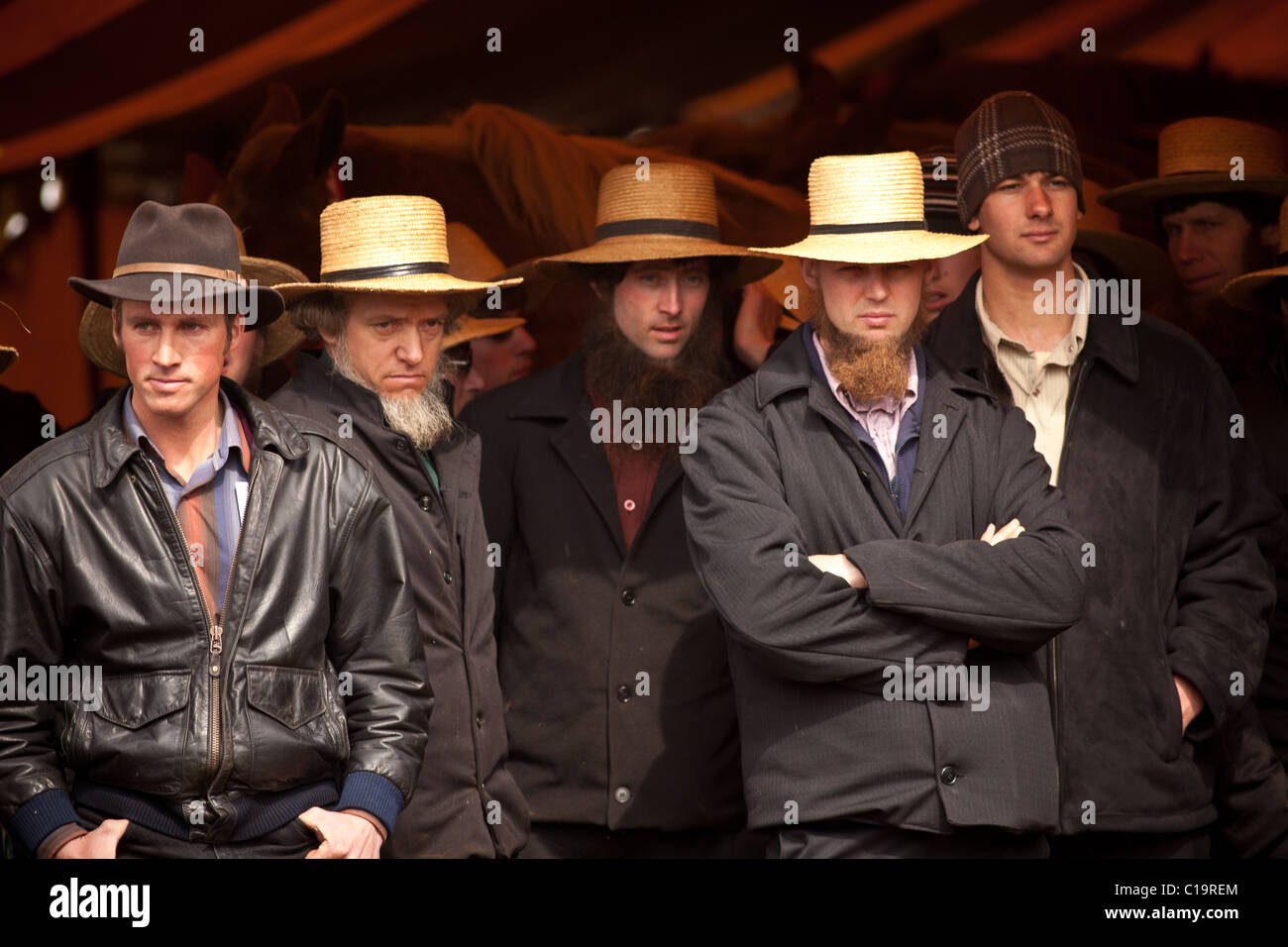 Amish men watch the horse auction during the Annual Mud Sale to support ...