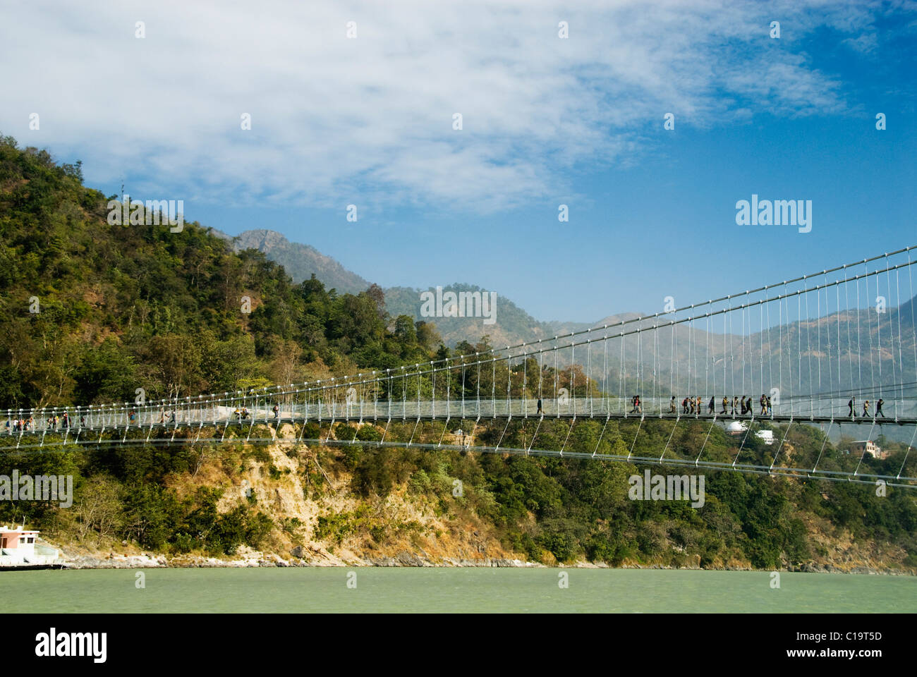 Suspension bridge across a river, Ram Jhula, Ganges River, Rishikesh ...
