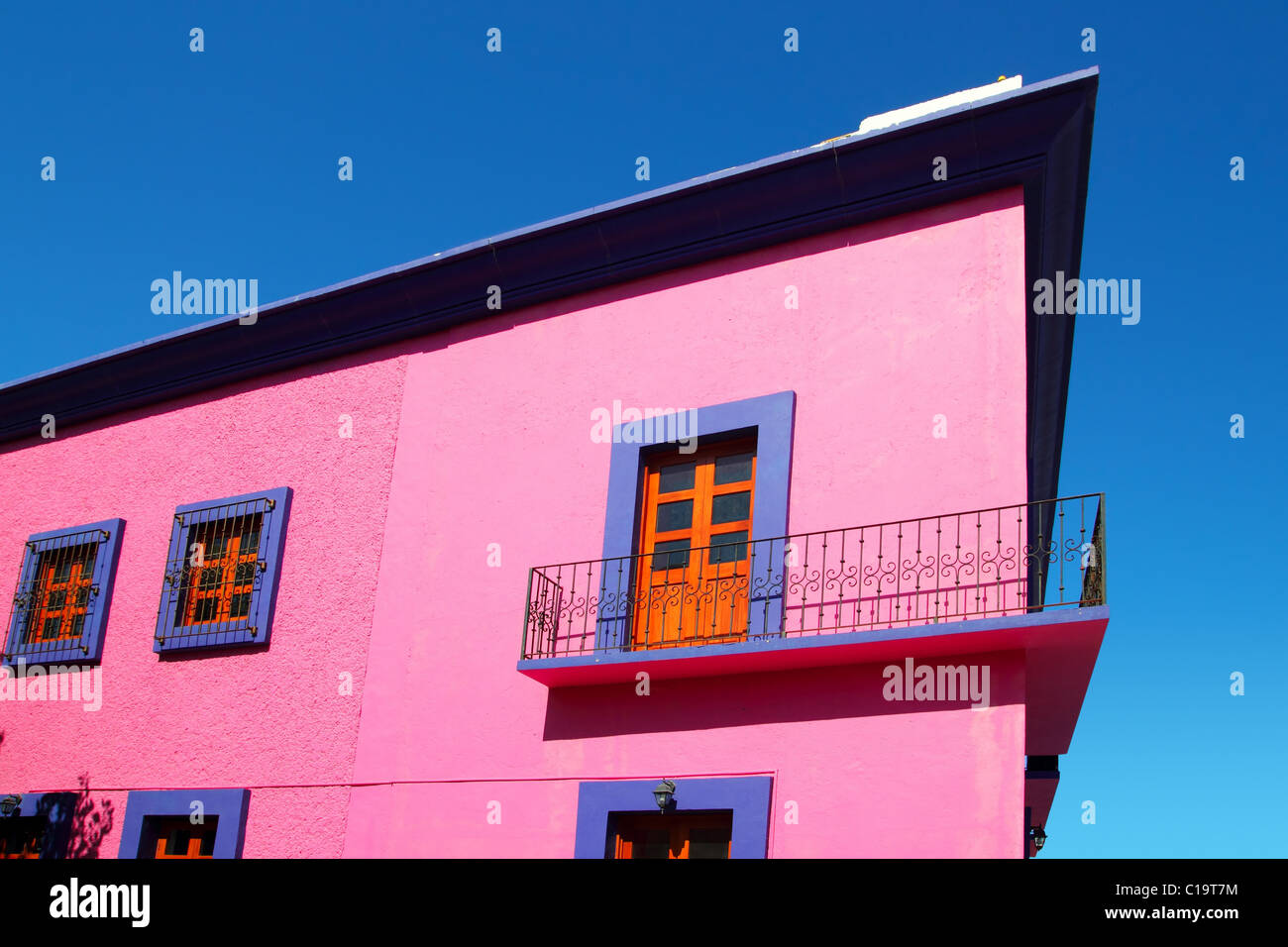 Mexican pink house facade detail wooden doors Stock Photo - Alamy