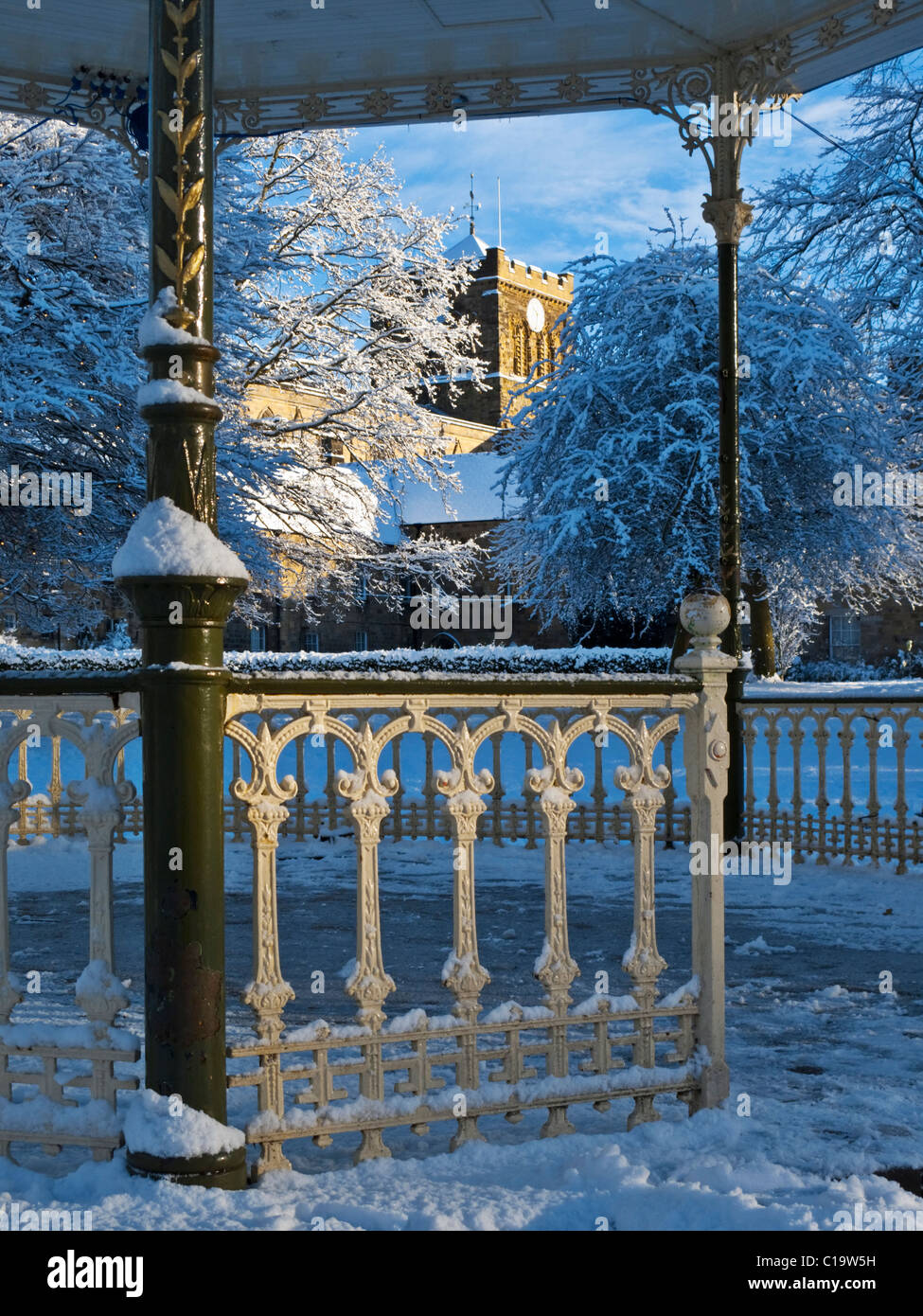 Hexham Abbey framed by a snow-covered bandstand in the Sele Park ...