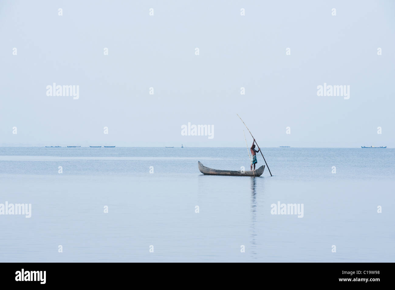 Man rowing a boat in a lagoon, Kerala Backwaters, Alleppey, Alappuzha ...