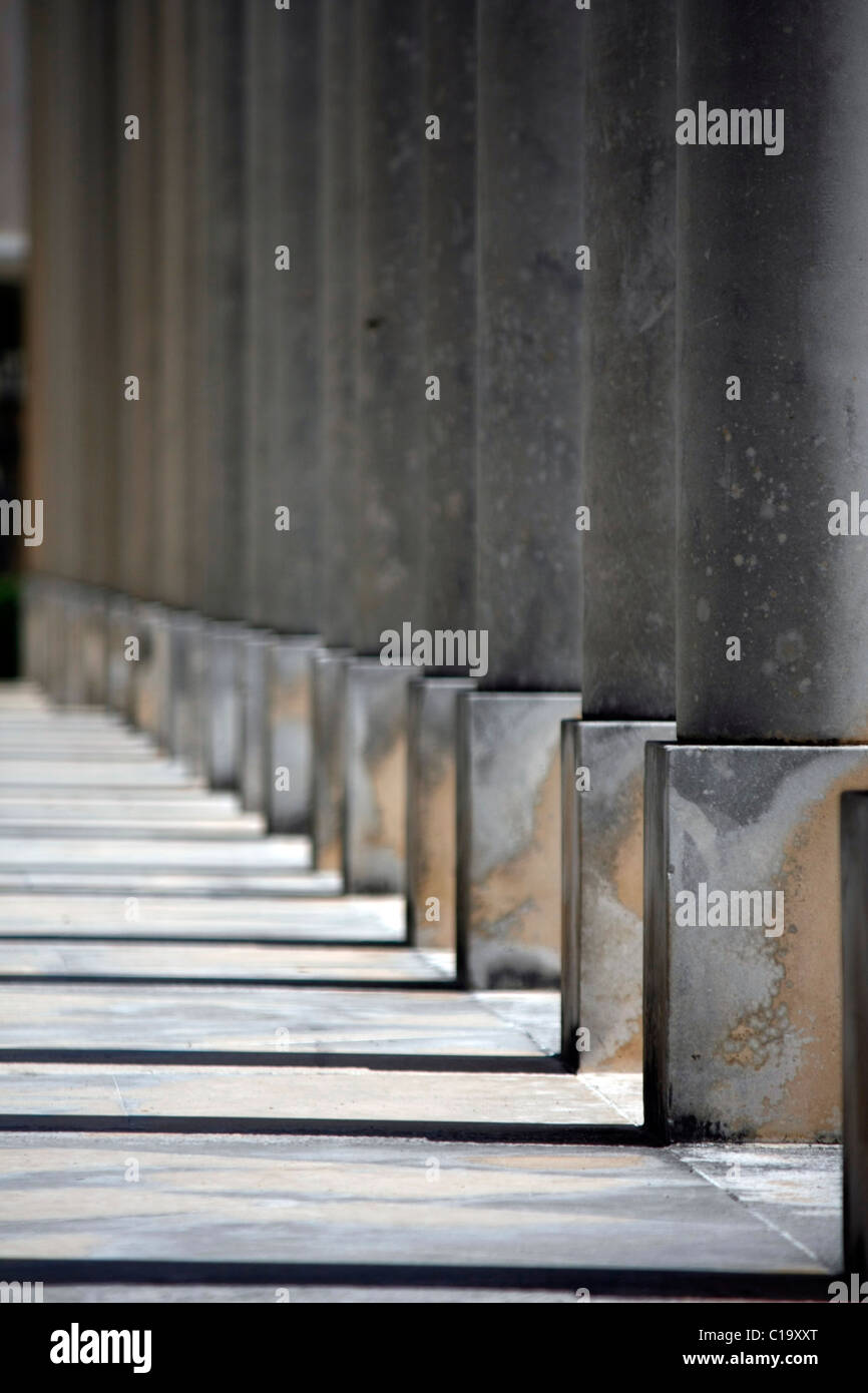 View of a row of aligned pillars on some building Stock Photo - Alamy