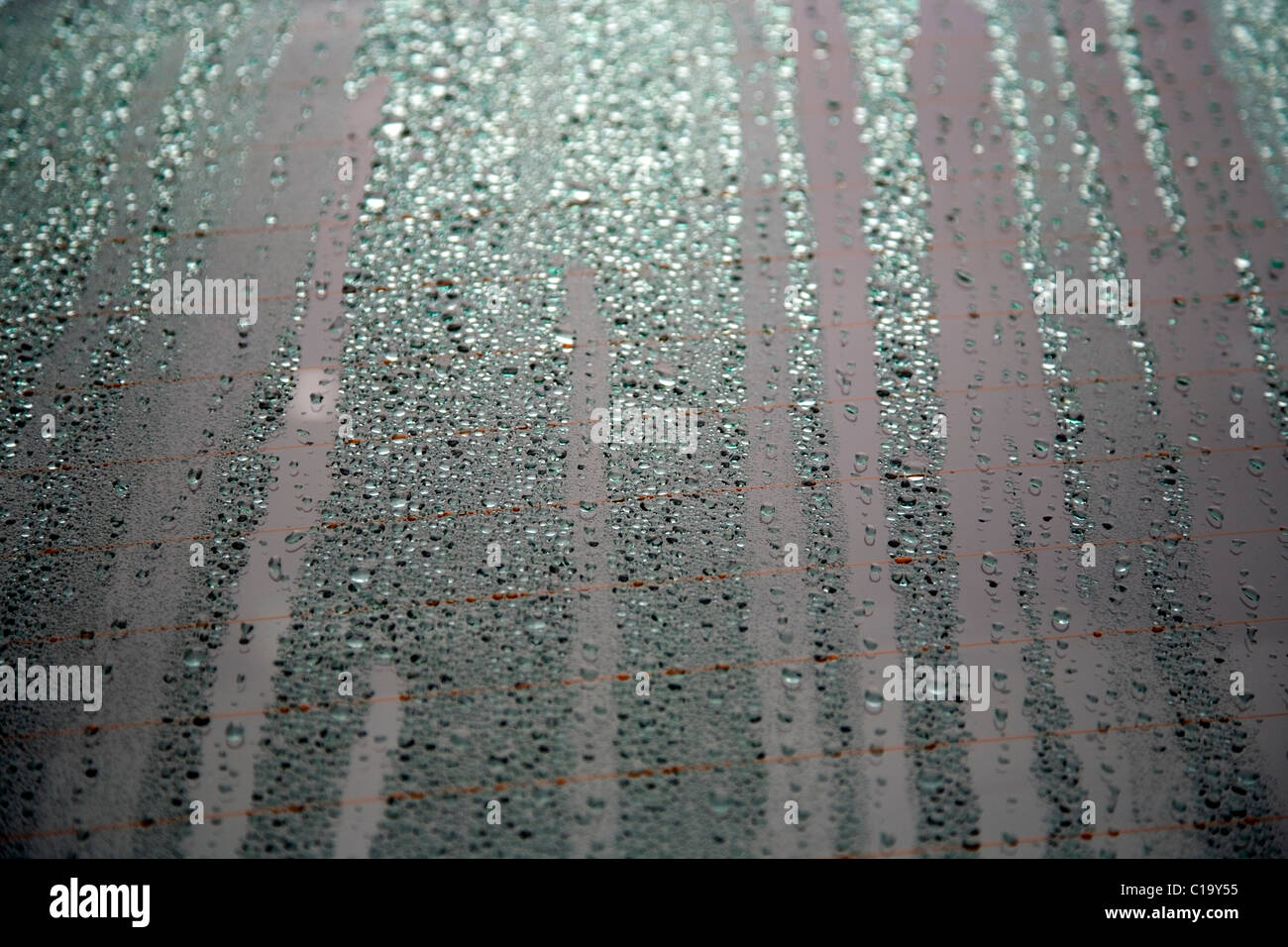 Dew running down car window backglass Stock Photo - Alamy