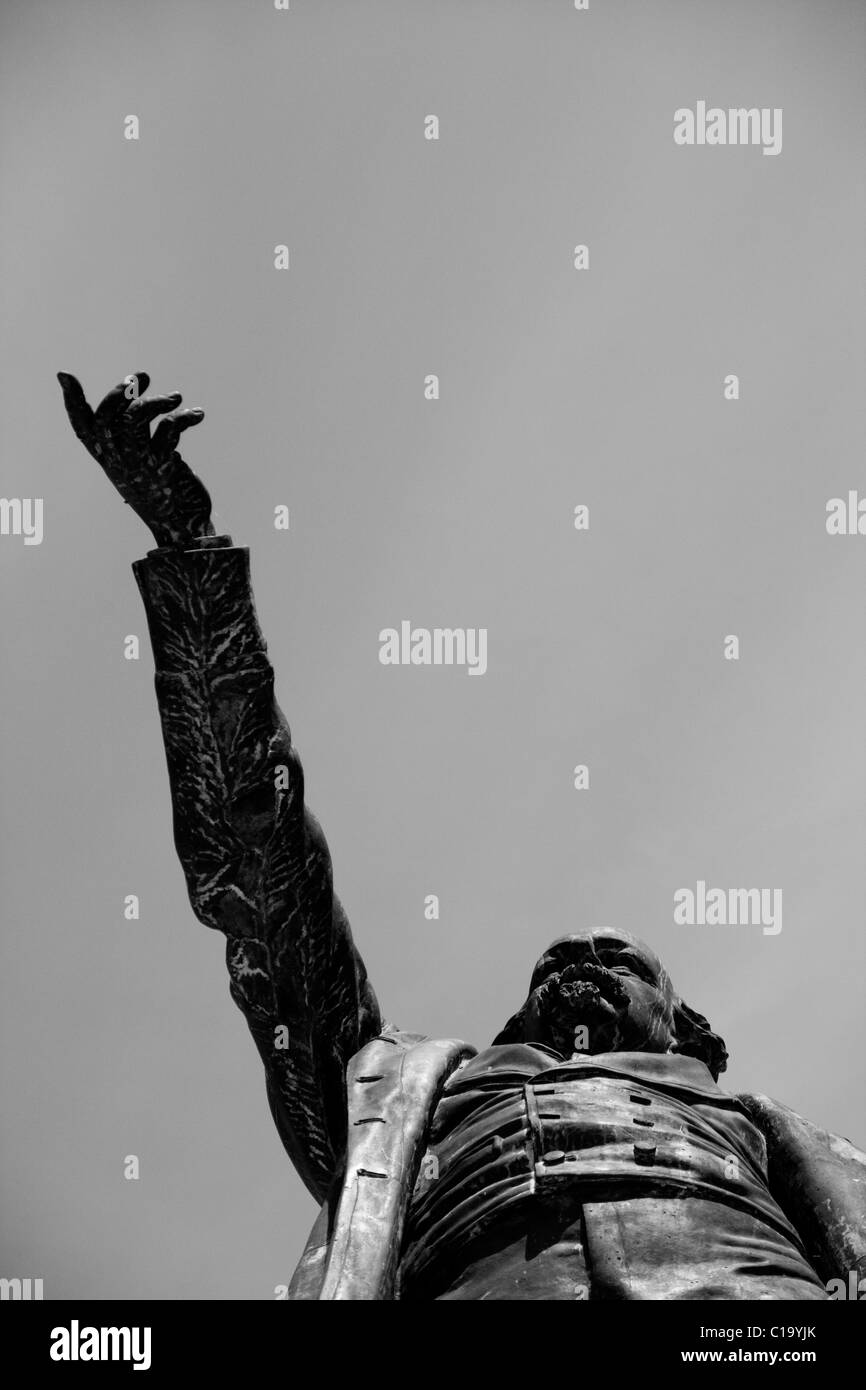 Upward view of a statue of a man pointing out his hand Stock Photo - Alamy