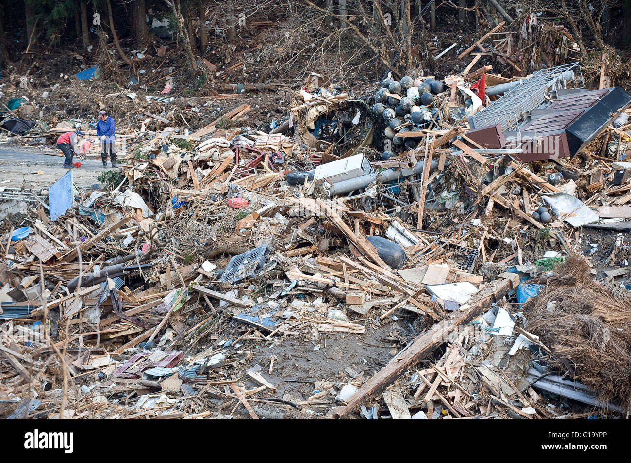 Shattered homes and other debris that was swept inland by the tsunami ...