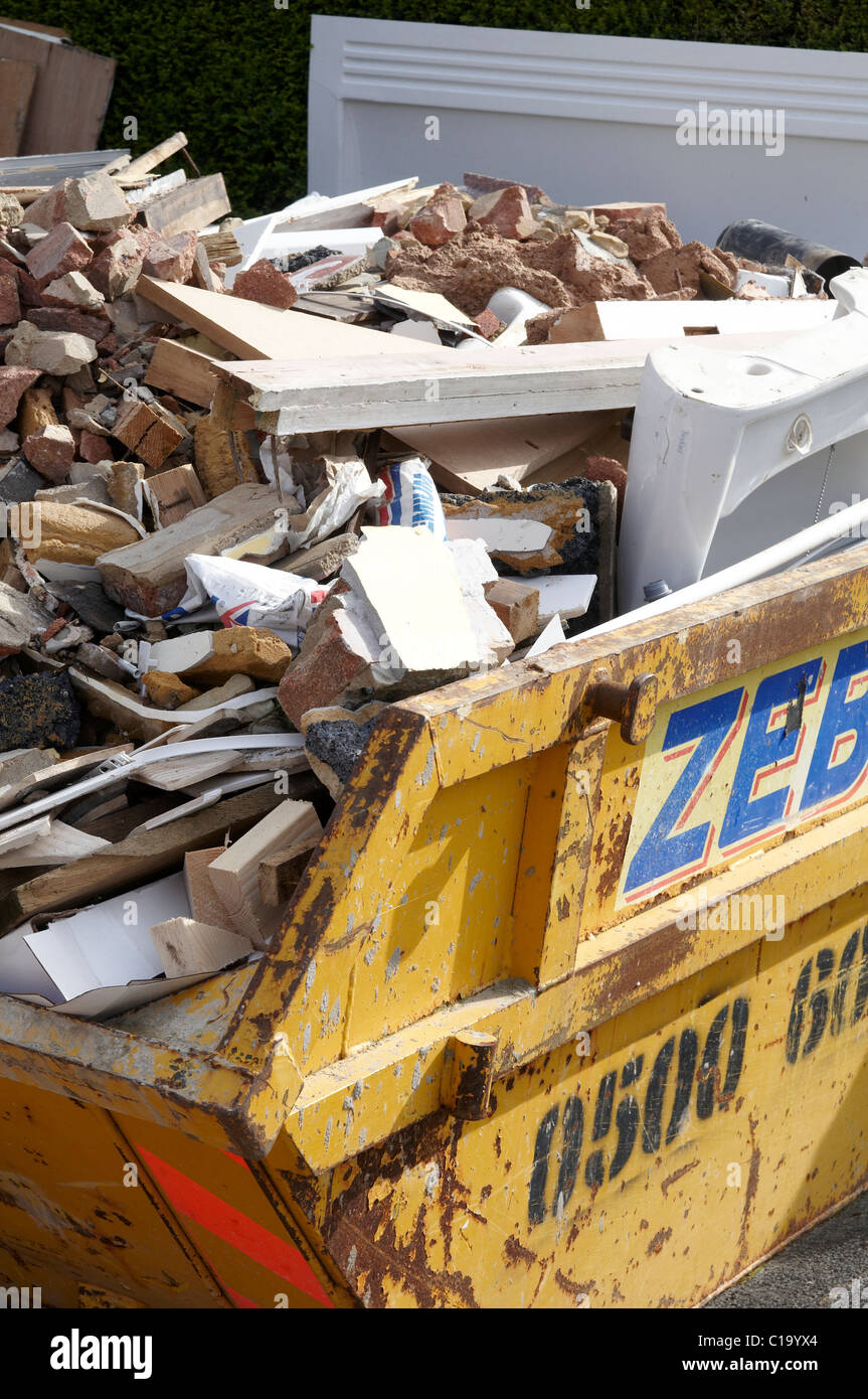 Builder's skip with rubble and other waste Stock Photo - Alamy