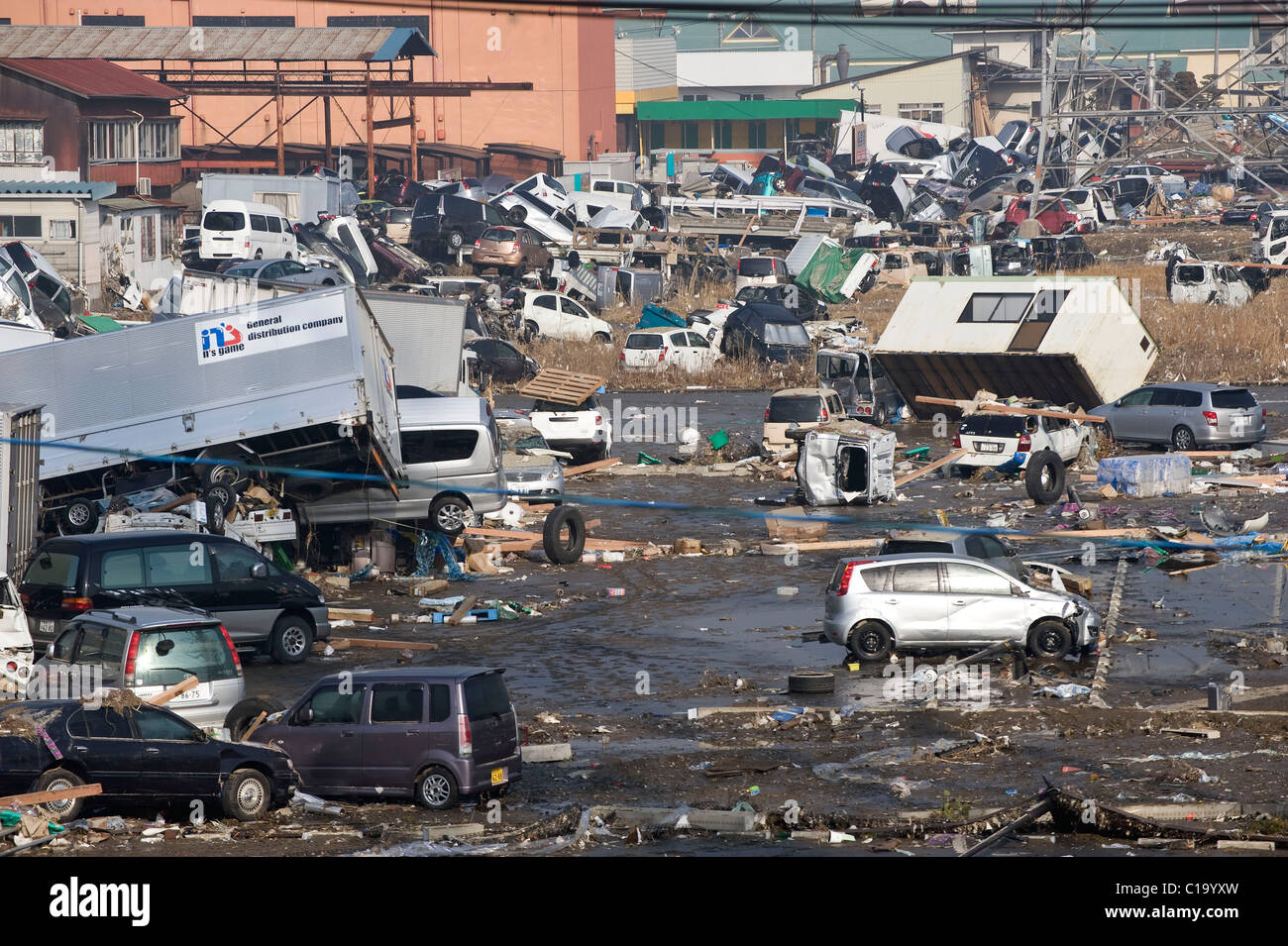 Photo shows cars and trucks that were swept inland by the tsunami that ...
