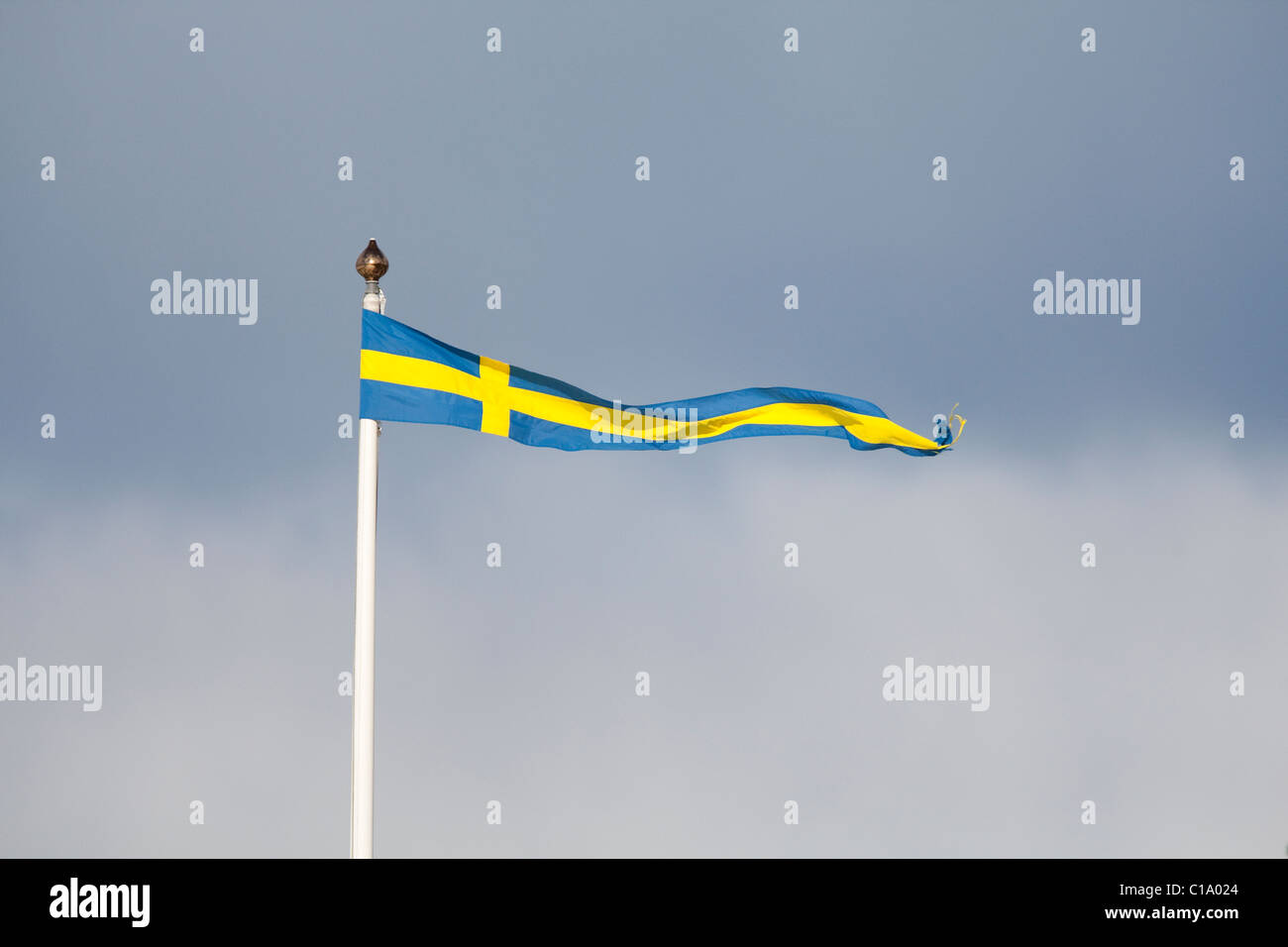 Swedish flag in the wind and a blue sky Stock Photo - Alamy