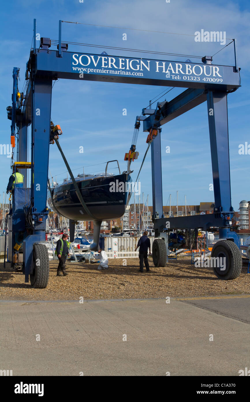 boat for repair being hoisted in boatyard Stock Photo - Alamy