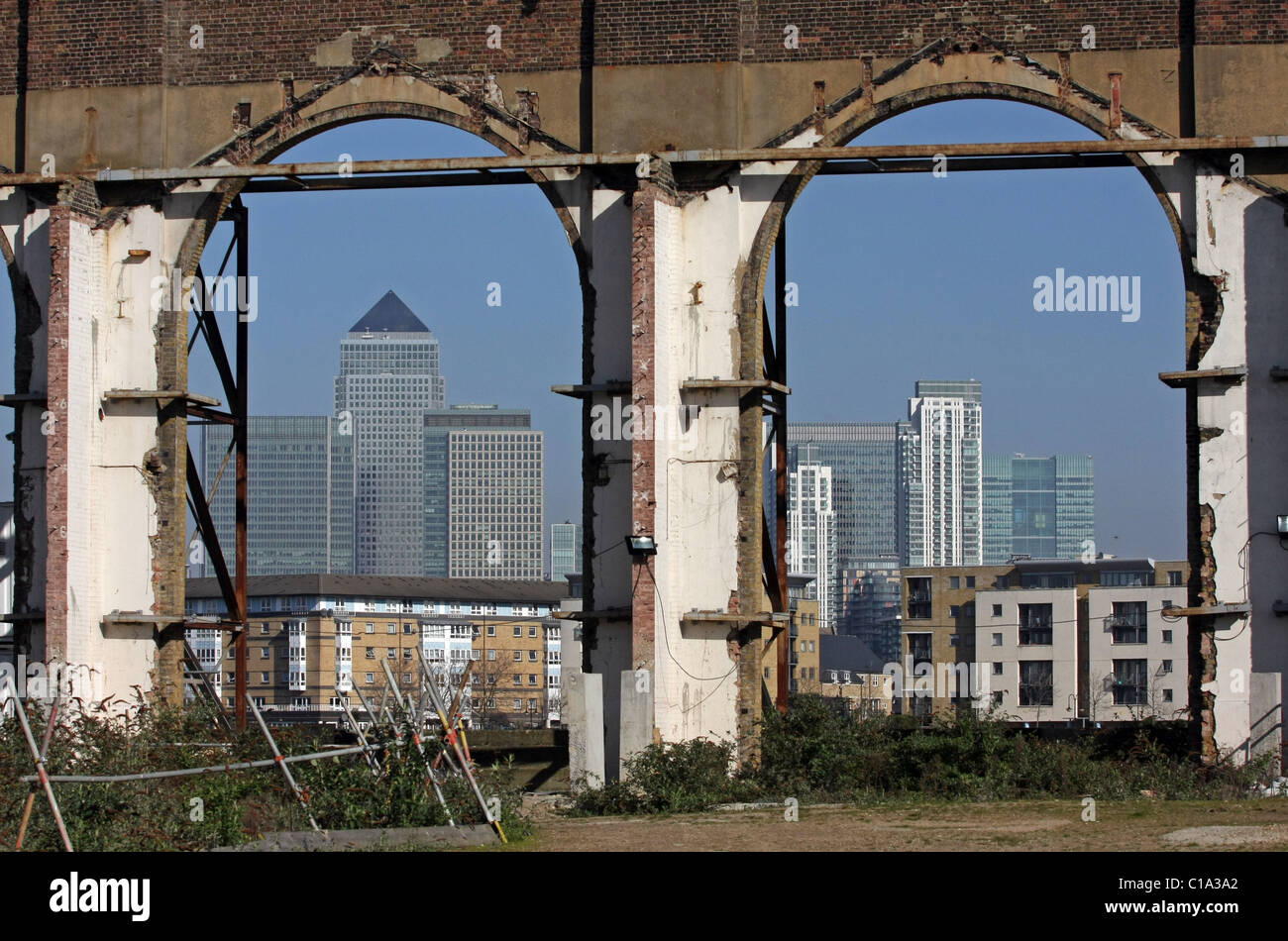 A view through a hole in the security gates of a demolition site of ...
