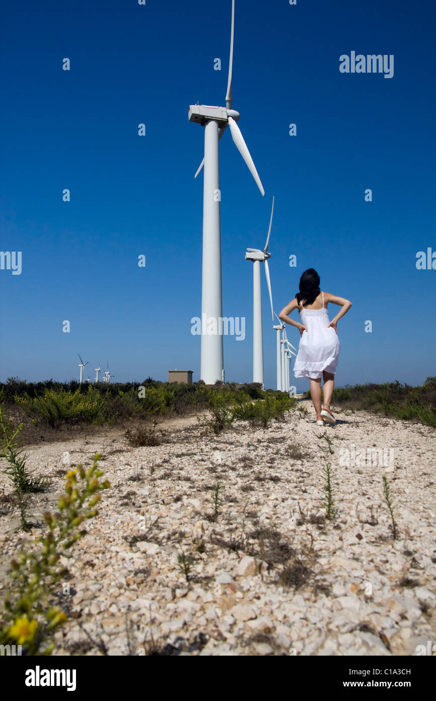 View of a young girl watching a windmill Stock Photo - Alamy