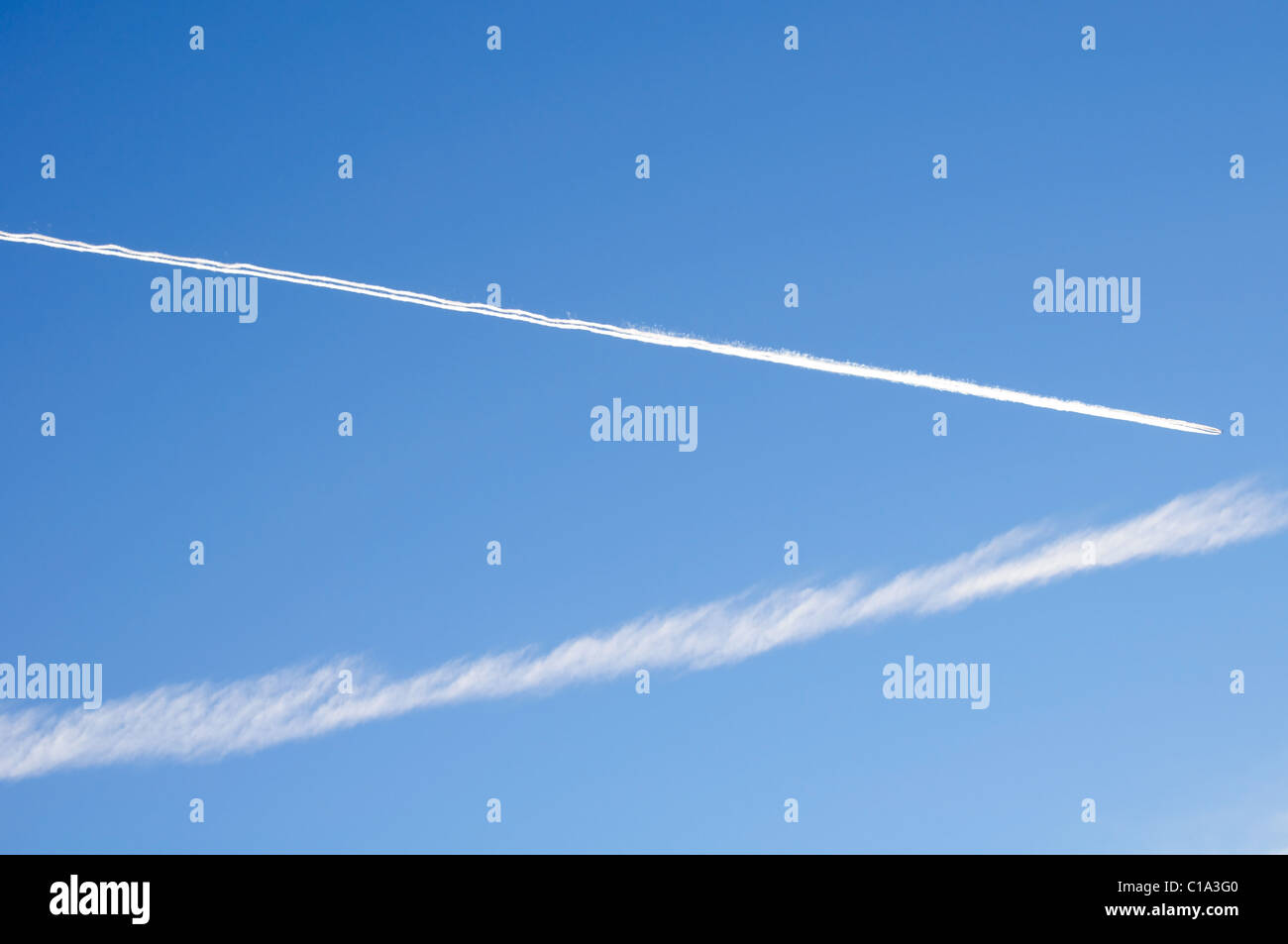 A shot of contrails in the sky Stock Photo - Alamy
