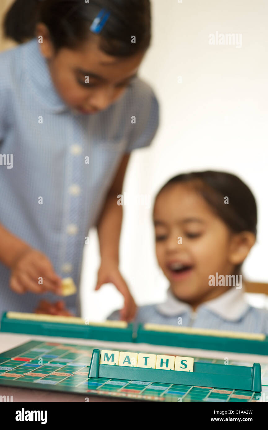 Kids playing scrabble game Stock Photo - Alamy