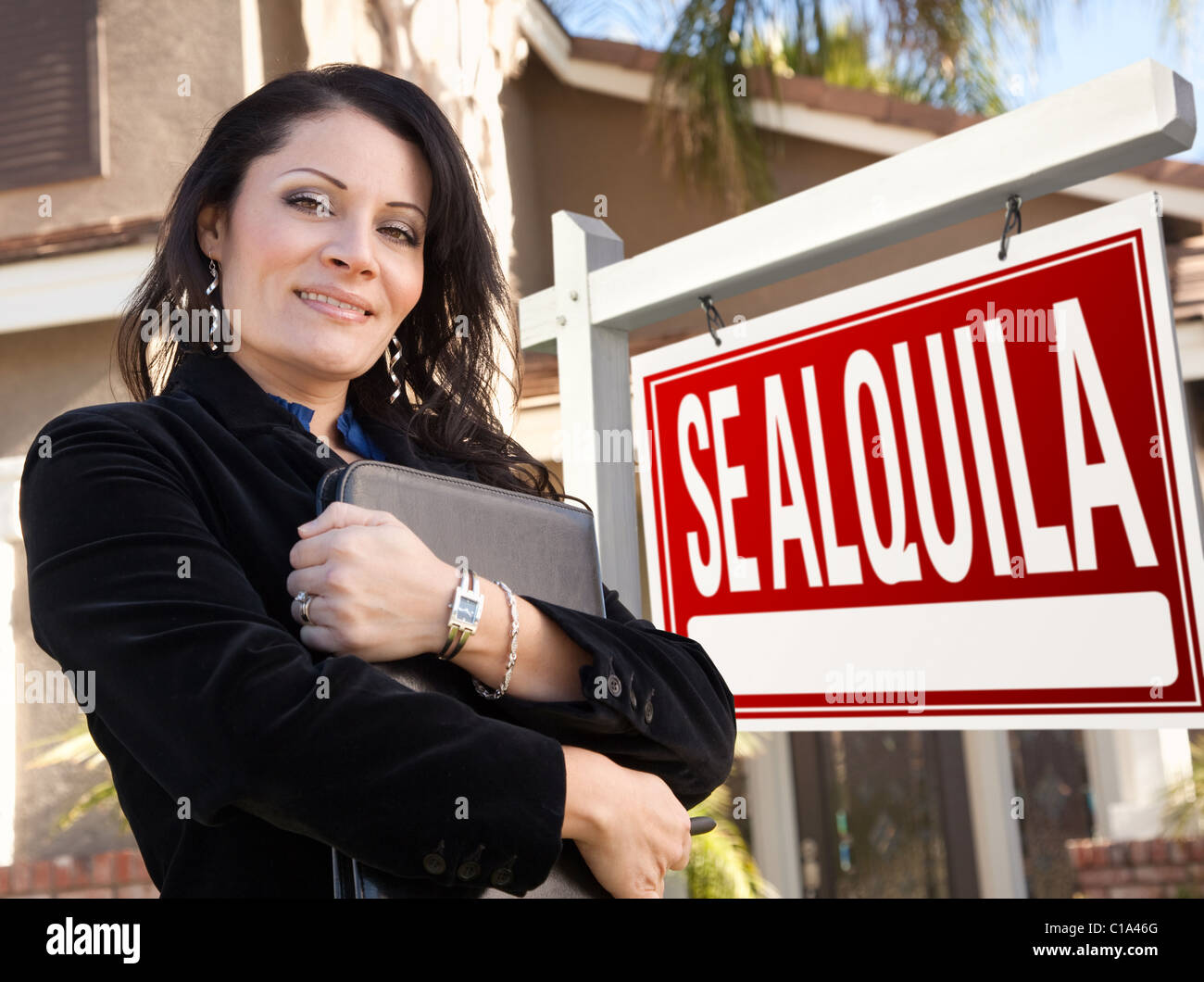 Proud, Attractive Hispanic Female Agent In Front of Spanish Se Alquila ...