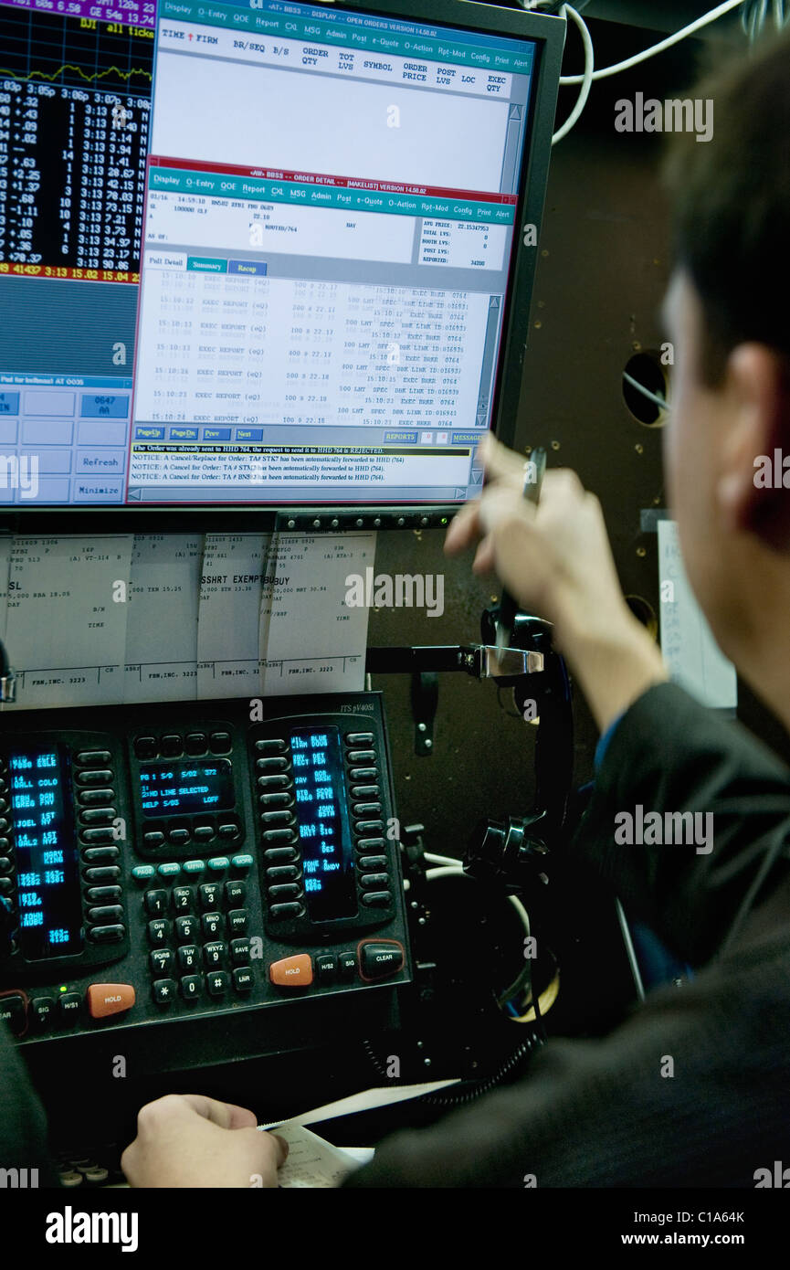 A trader on the floor of the New York Stock Exchange managing trade ...