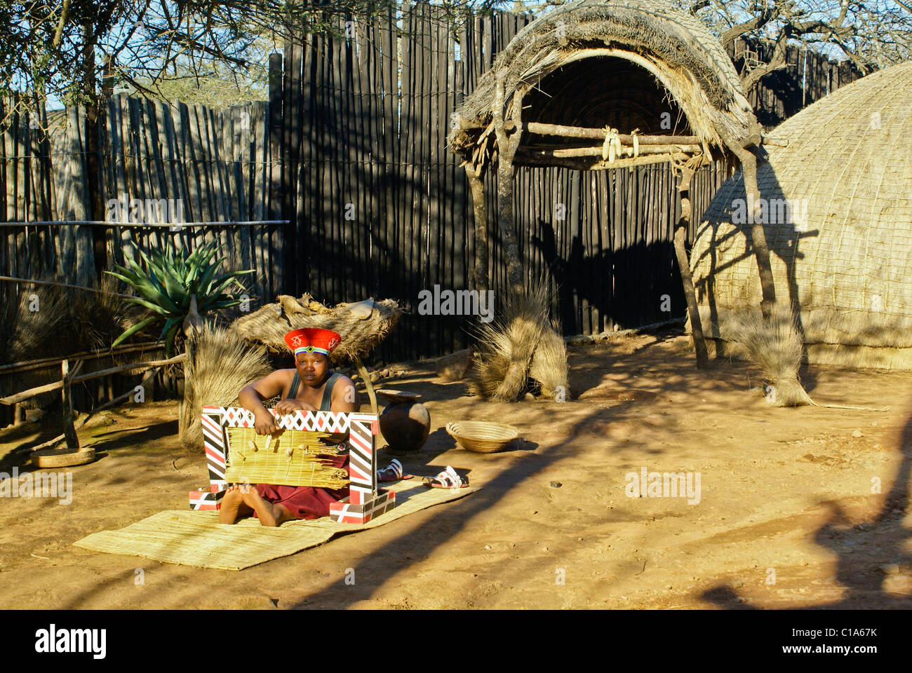Zulu woman weaving reed mat, Shakaland, South Africa Stock Photo - Alamy