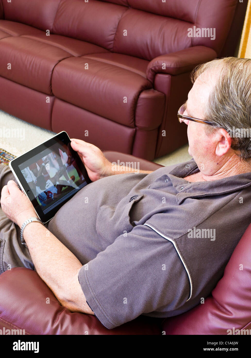 Senior Man reading The Times on his Apple iPad Stock Photo - Alamy