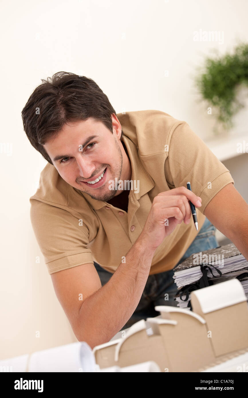 Successful architect man working at office with plans and architectural ...