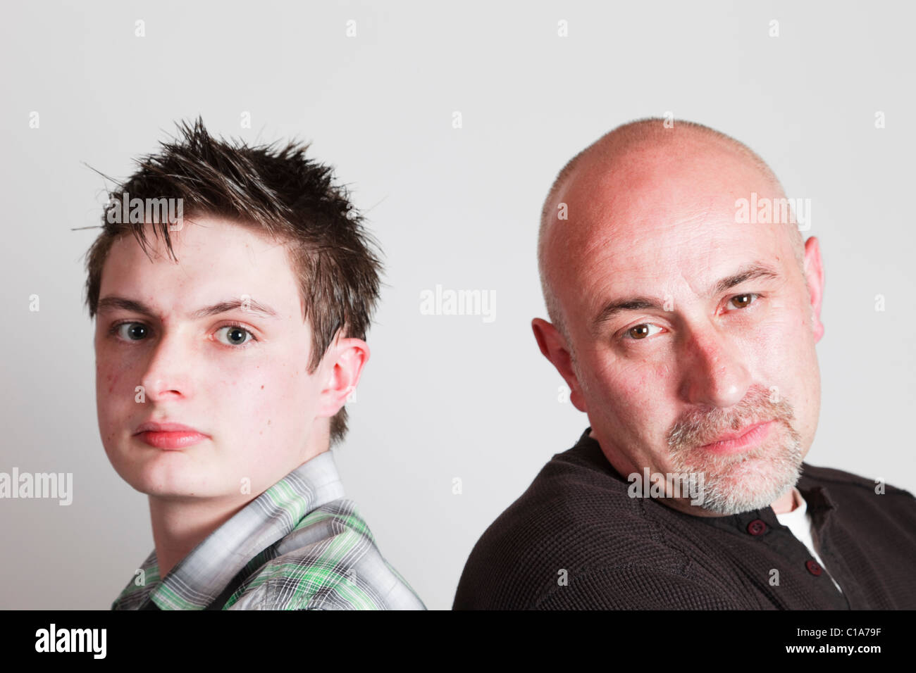 UK, Europe. Head and shoulders portrait of a father and teenage son ...